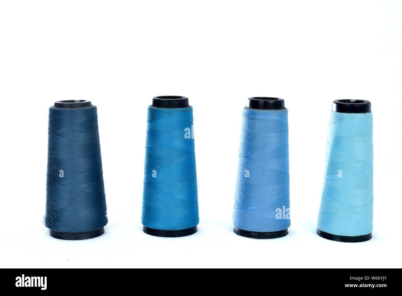 Colorful sewing thread reels on white background Stock Photo - Alamy