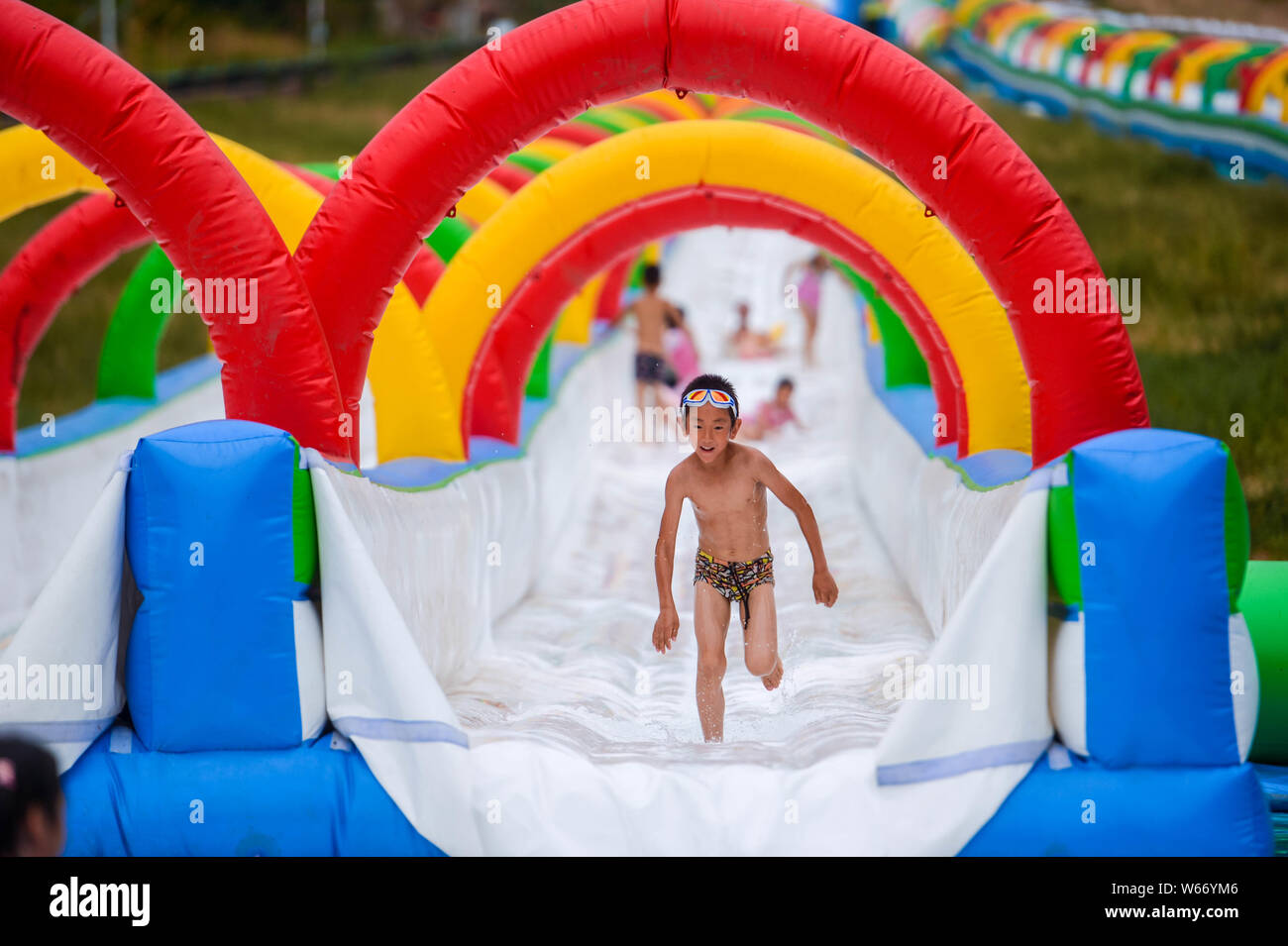Tourists play on Asia's longest water slide at Jingzhihu Resort in ...