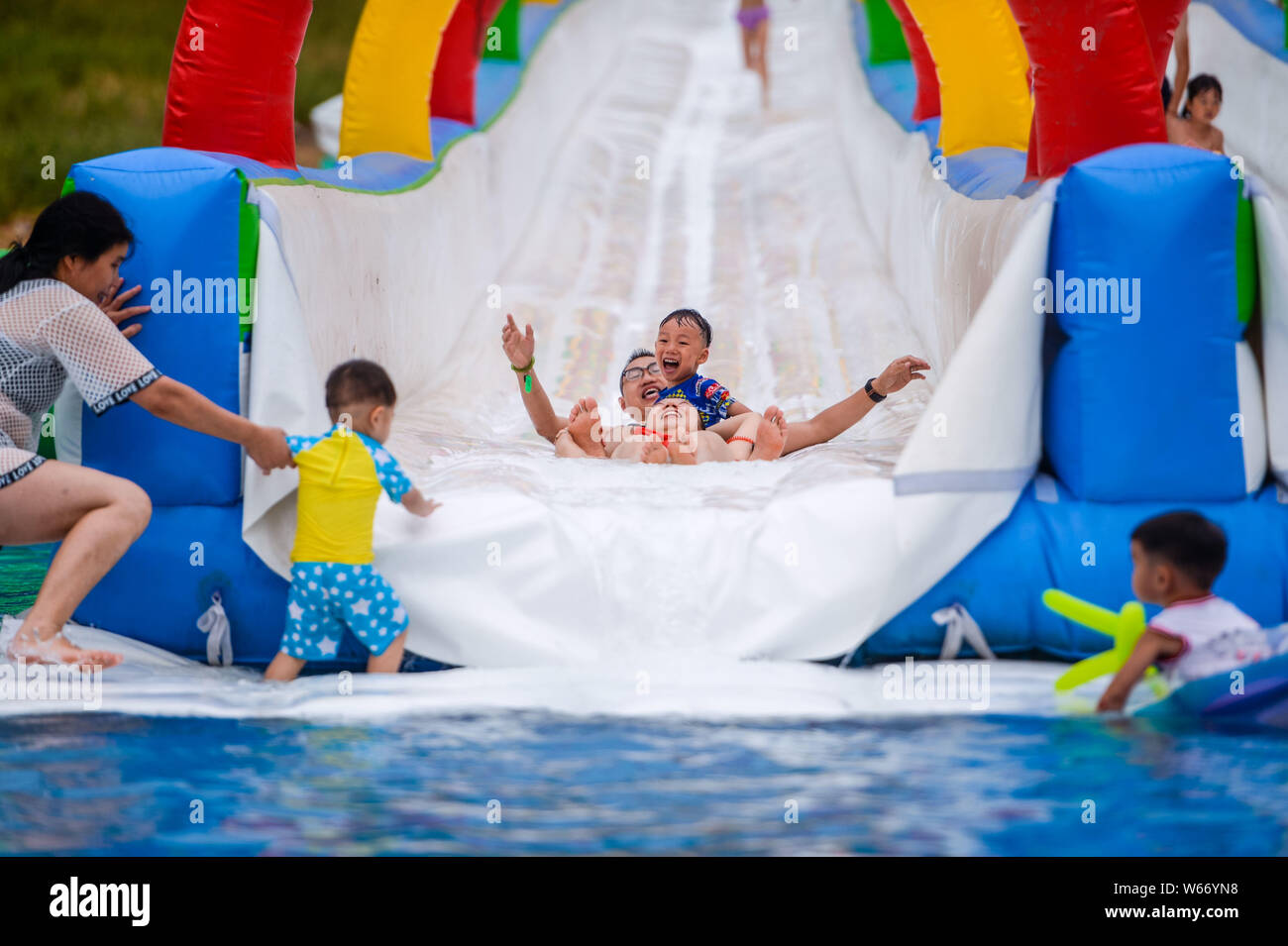 Tourists play on Asia's longest water slide at Jingzhihu Resort in ...