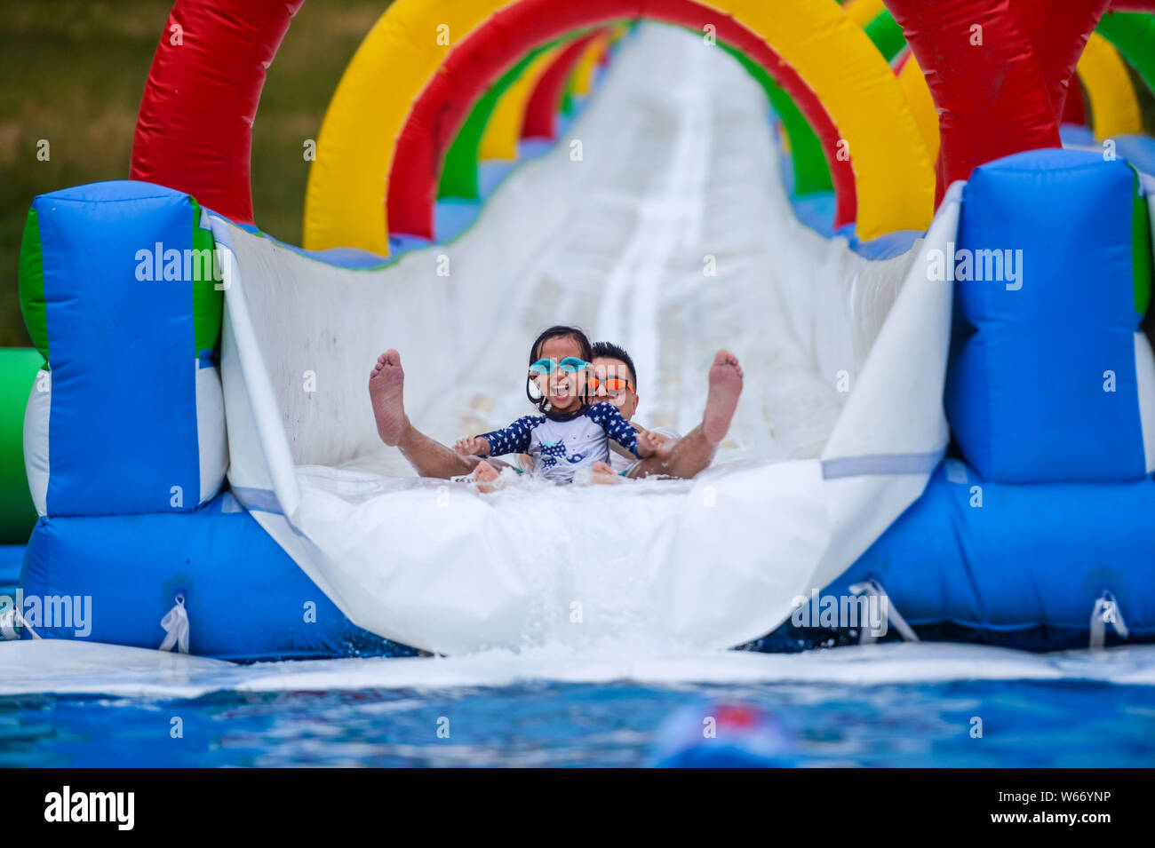 Tourists play on Asia's longest water slide at Jingzhihu Resort in ...