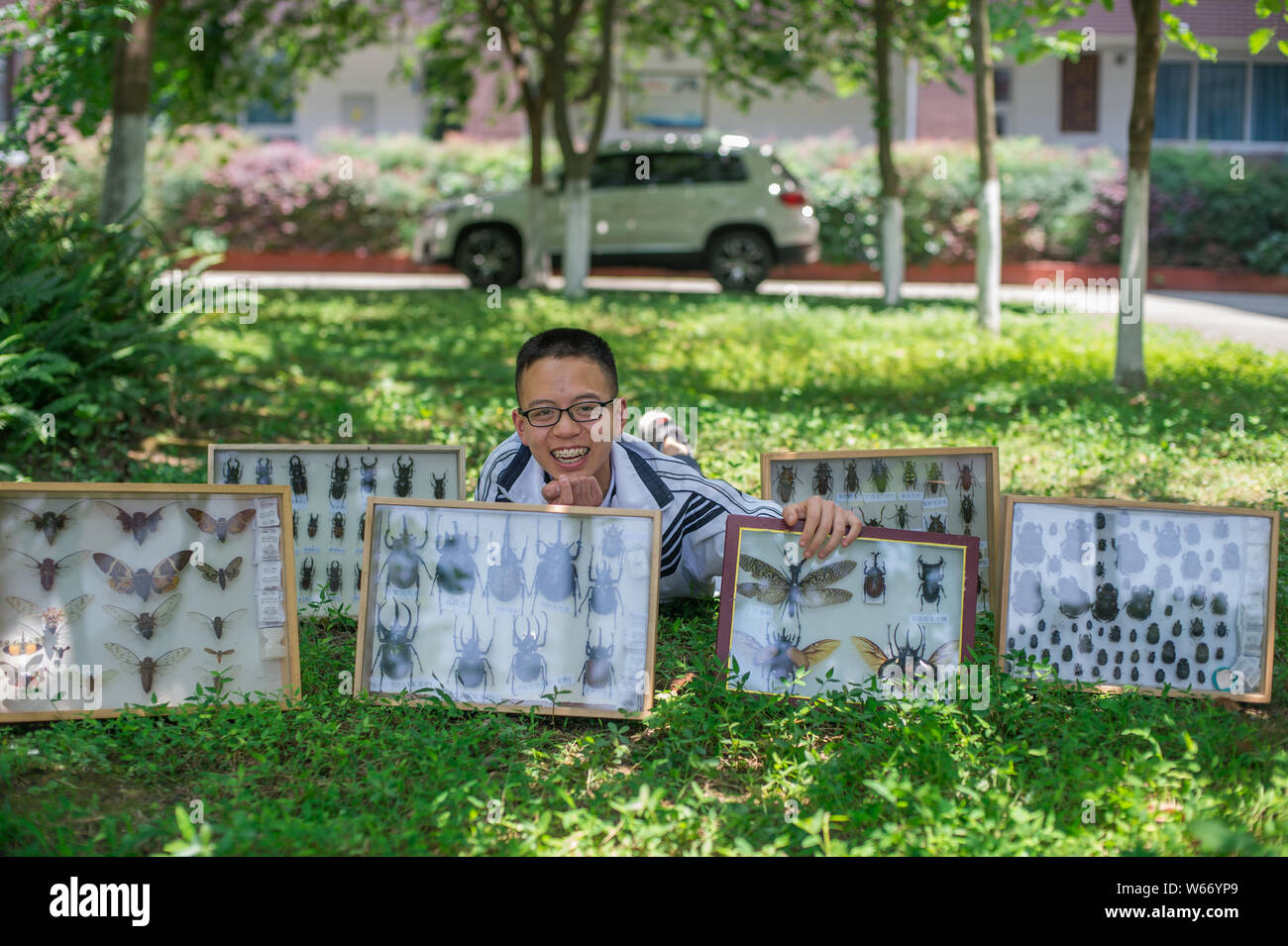 --FILE--16-year-old Chinese boy Xiong Haoyang poses for photos with more than 800 insect ...