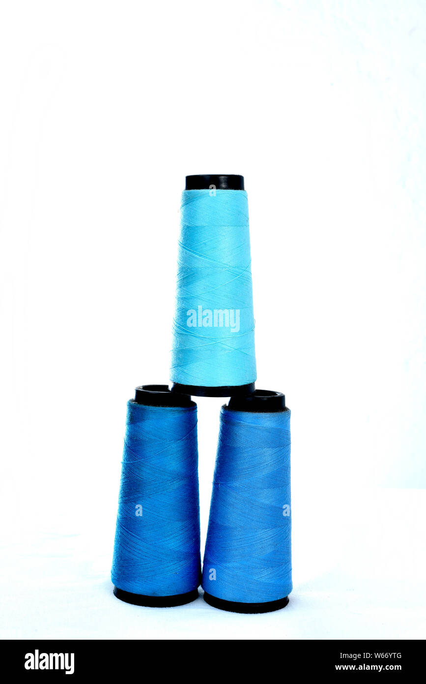 Colorful sewing thread reels on white background Stock Photo - Alamy