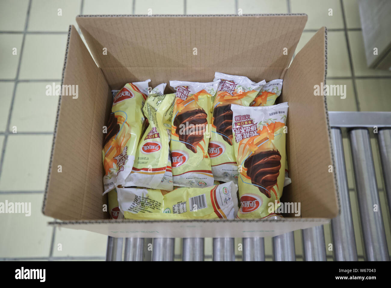 Yili torch ice creams are being produced on the assembly line at a ...