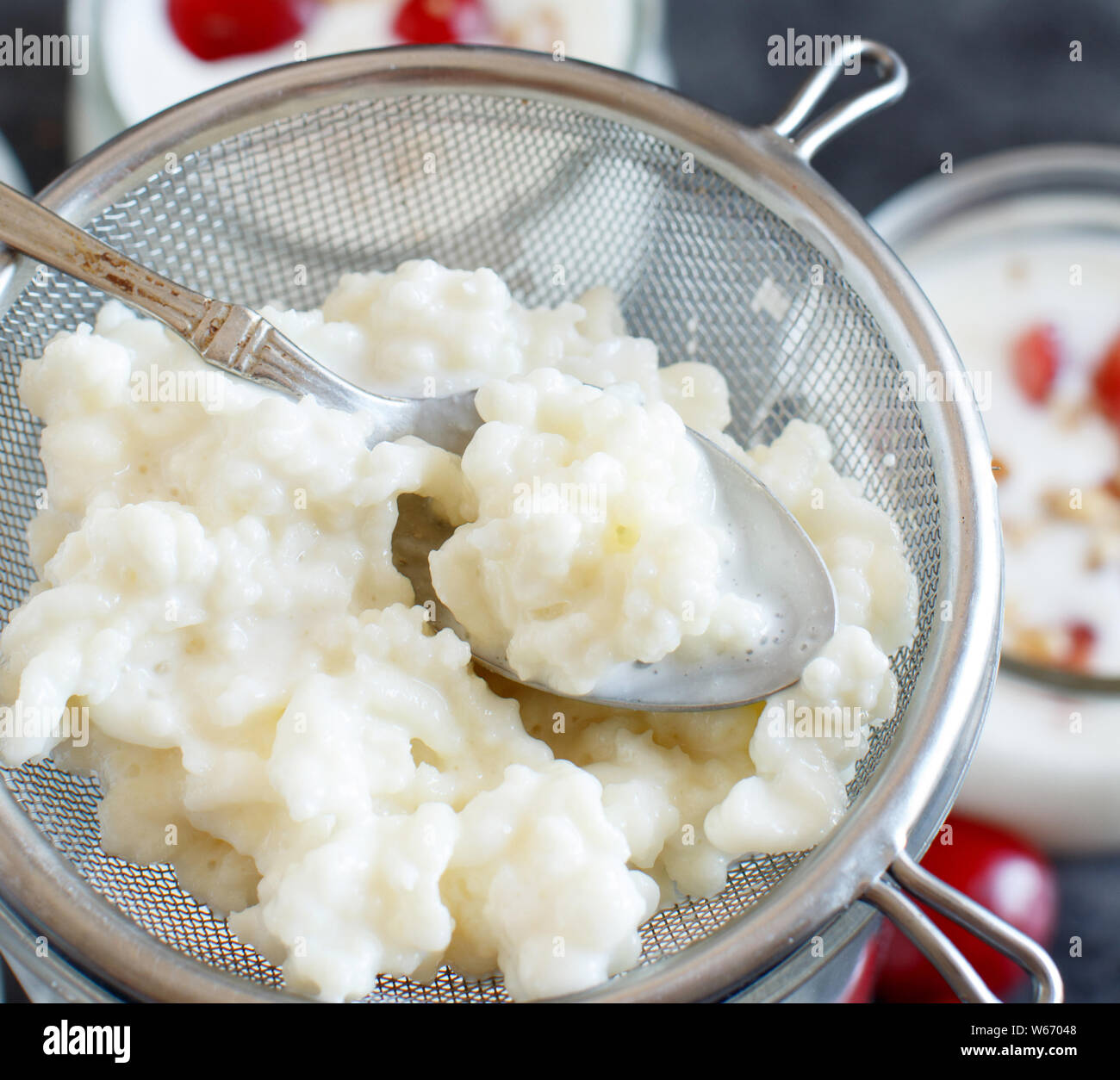 Kefir grains and fermented drink kefir close up Stock Photo - Alamy