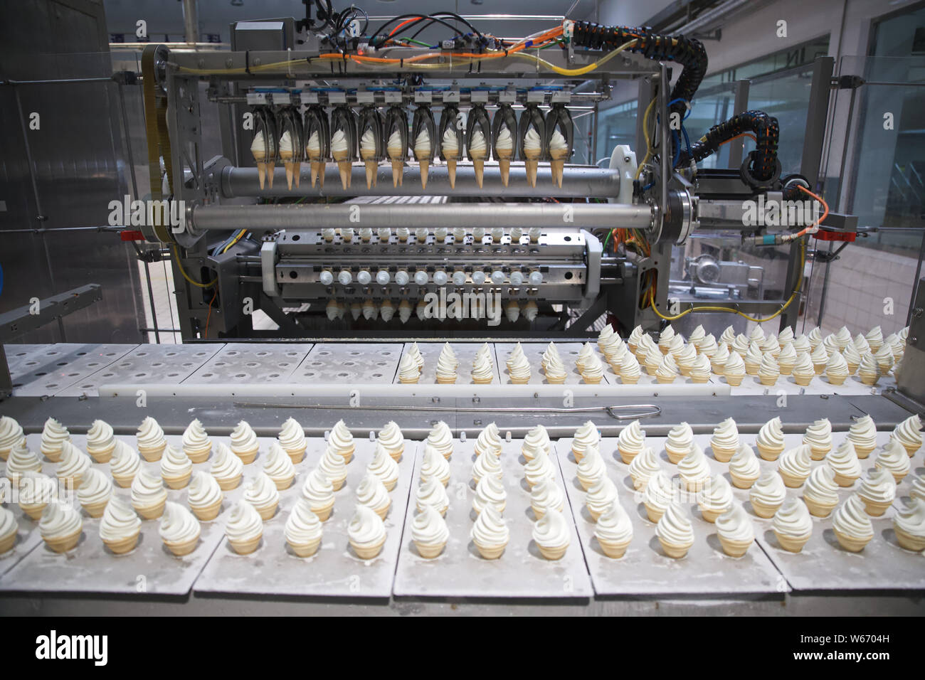 Yili torch ice creams are being produced on the assembly line at a ...