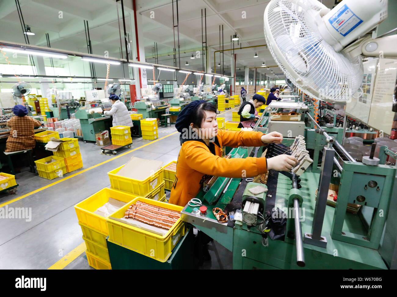 --FILE--Female Chinese workers produce components and parts of electric ...