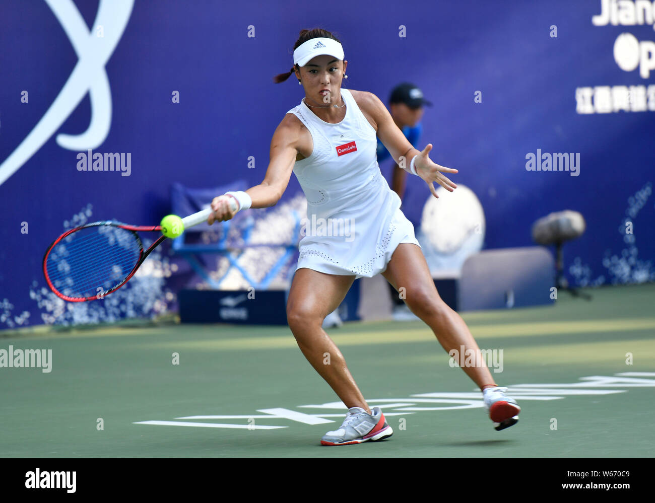 Wang Qiang of China returns a shot to Zheng Saisai of China in their ...