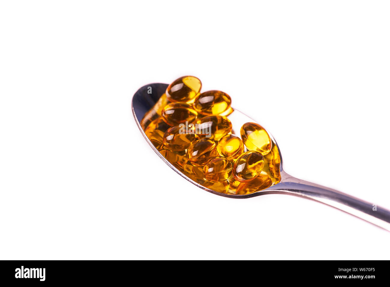 Yellow capsules teaspoon hi-res stock photography and images - Alamy