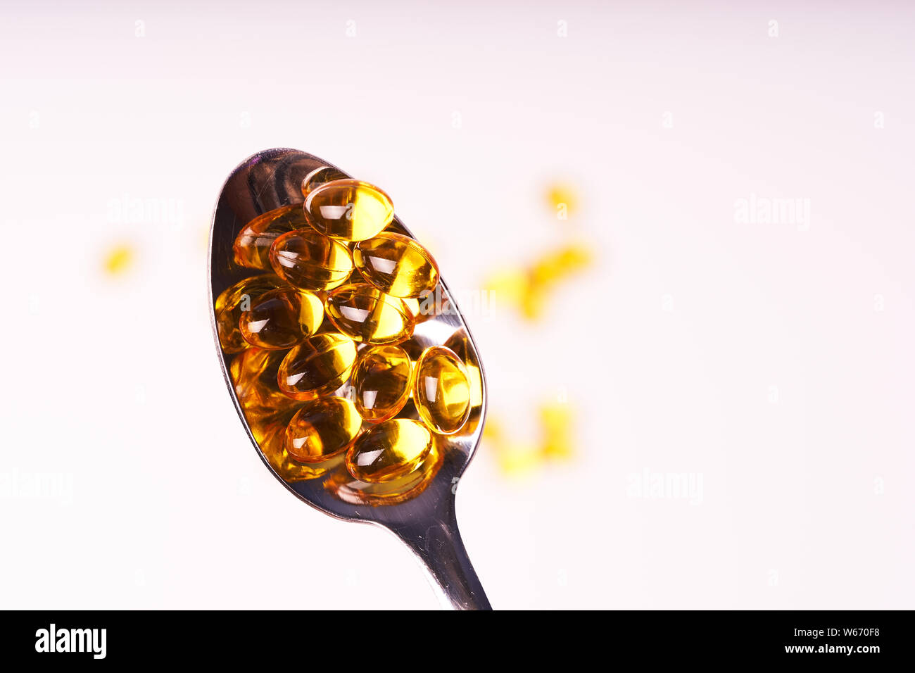 Yellow capsules teaspoon hi-res stock photography and images - Alamy