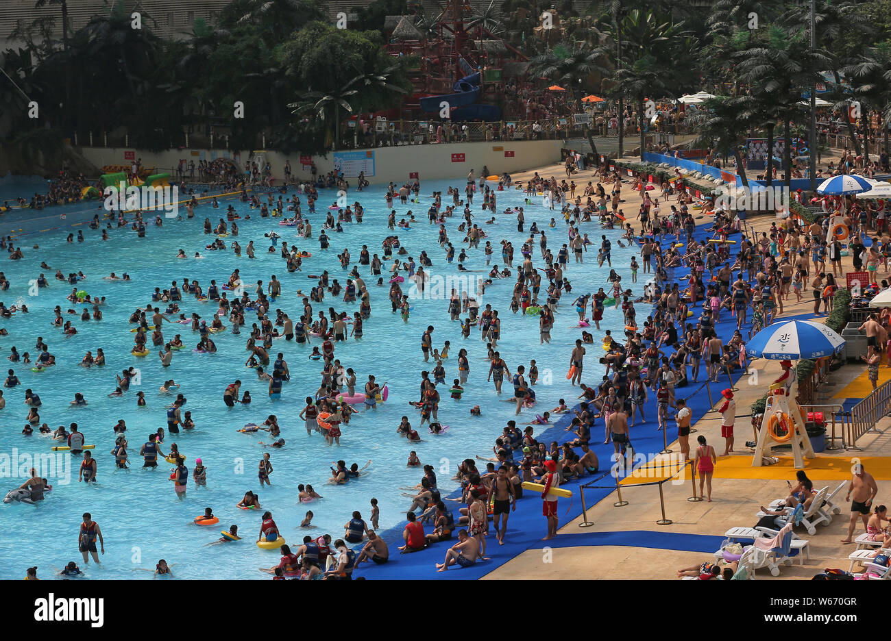 Chinese holidaymakers crowd a water park to cool off on a scorching day ...