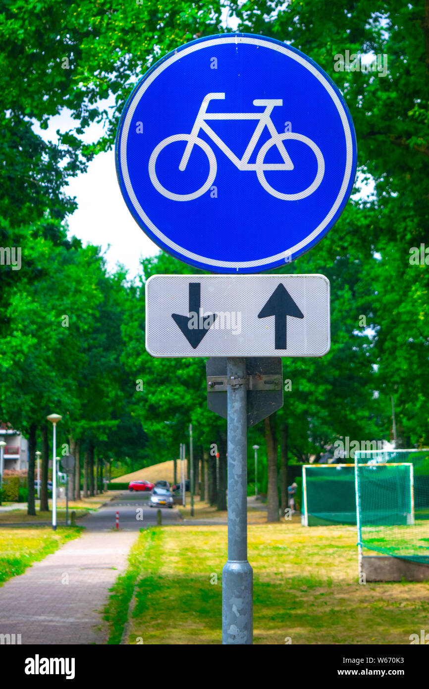 Dutch road sign: bike lane, round blue sign Stock Photo - Alamy