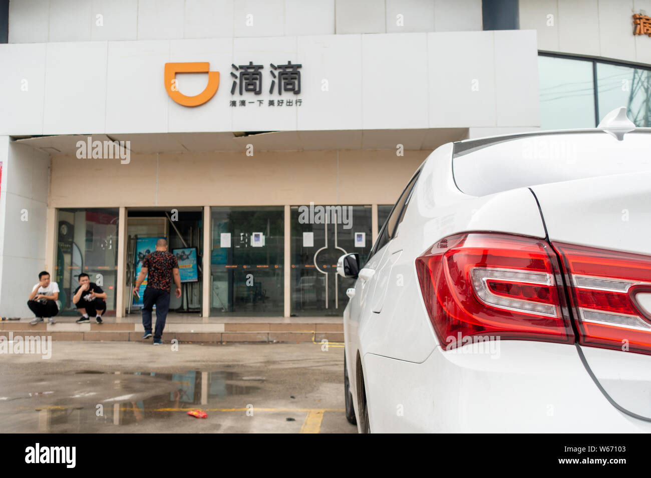 --FILE--Cars are parked in front of a Didi Club of the taxi-hailing and ...