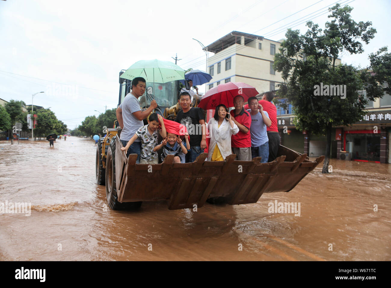 Chinese rescuers evacuate local residents in floodwater caused by heavy ...