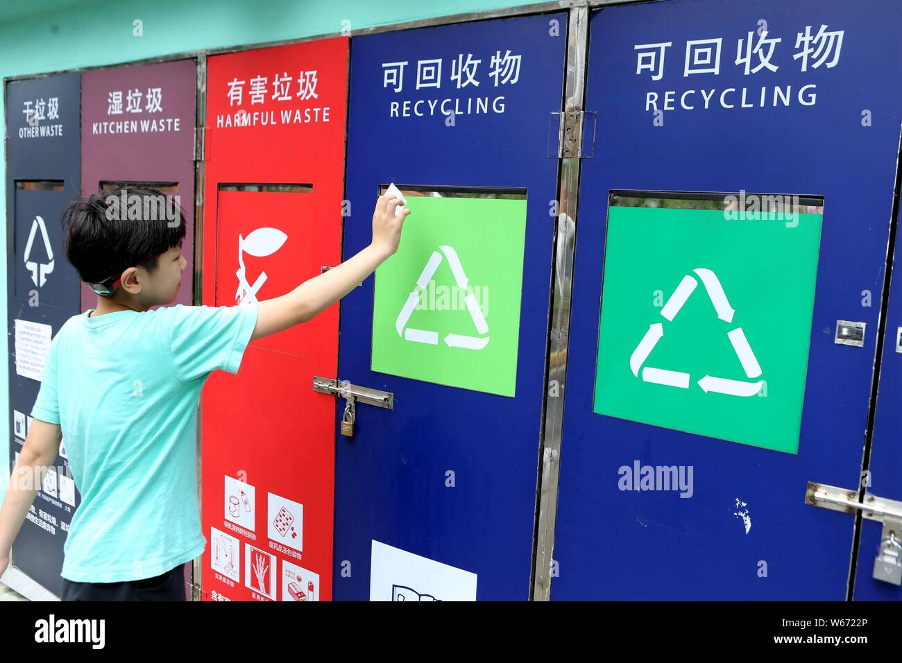 A young boy throws rubbish into a smart bin deployed to meet the new ...