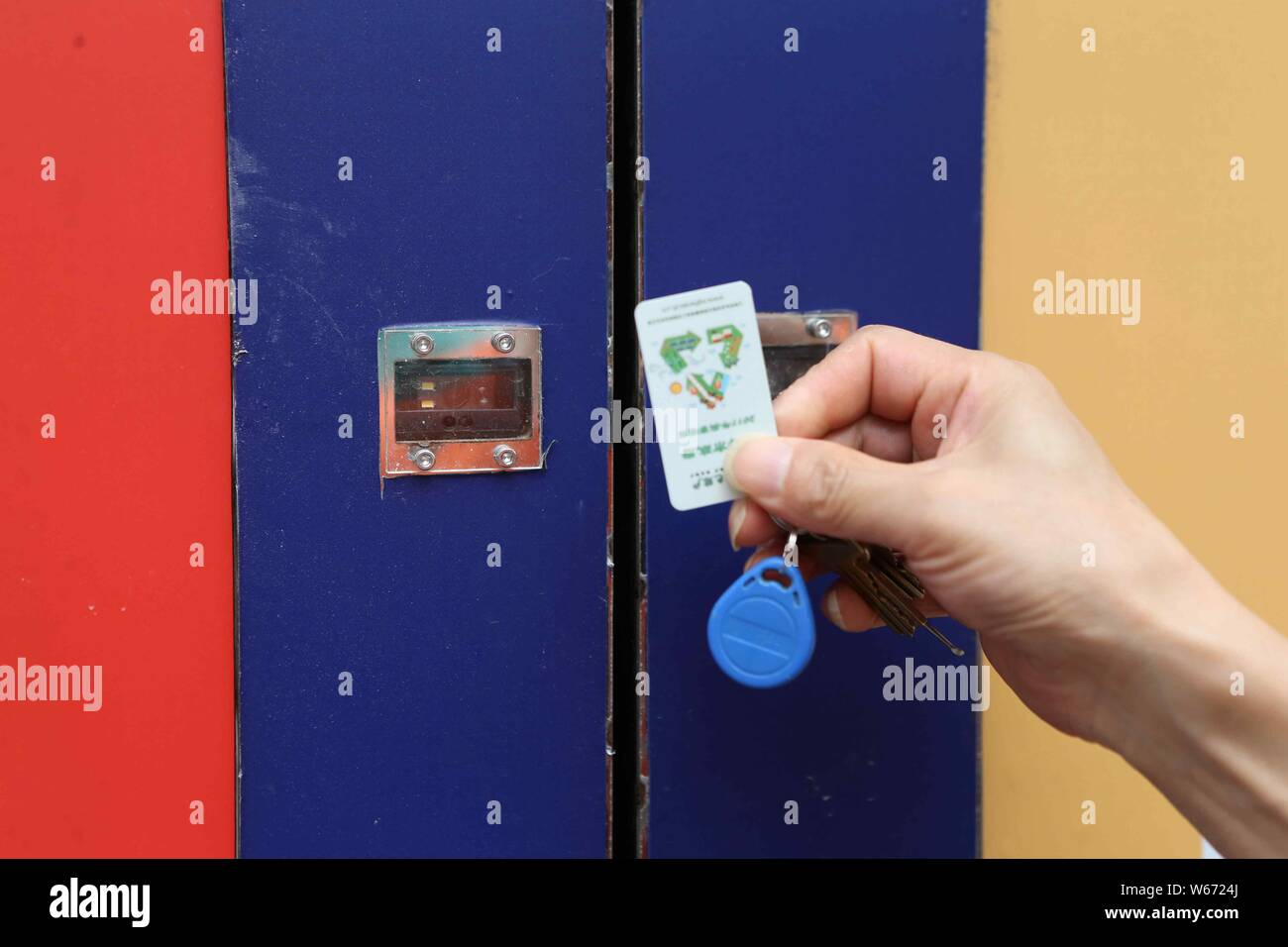 A local resident opens a smart bin deployed to meet the new garbage ...