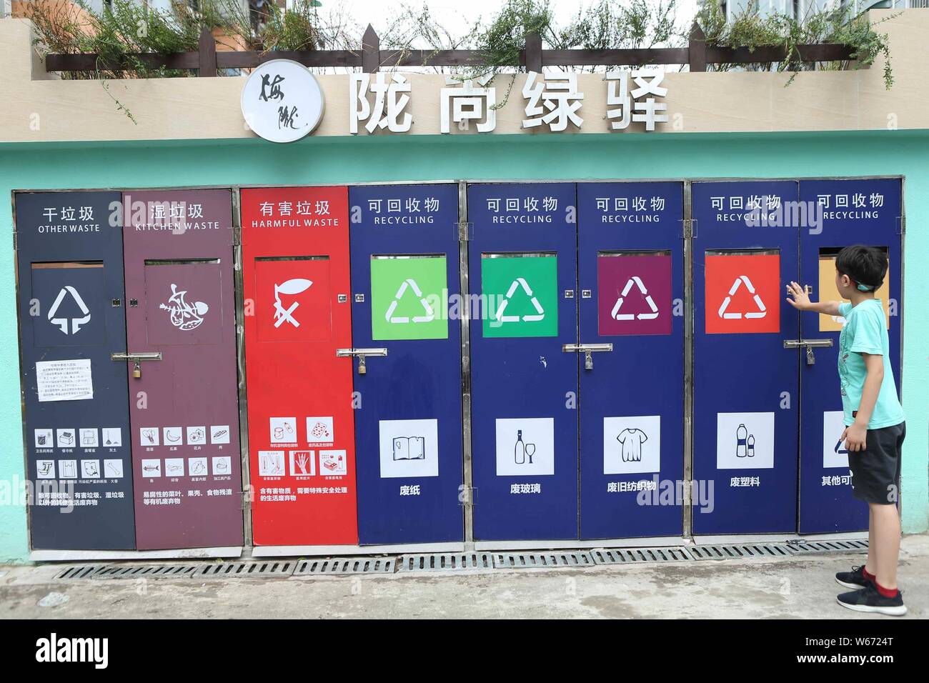 A local resident walks past a smart bin deployed to meet the new ...