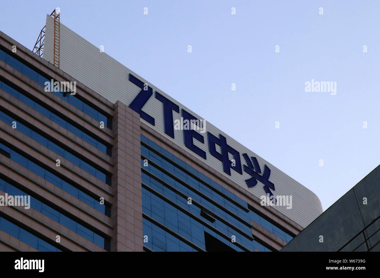 --FILE--A signboard of ZTE is seen on the rooftop of an office building ...