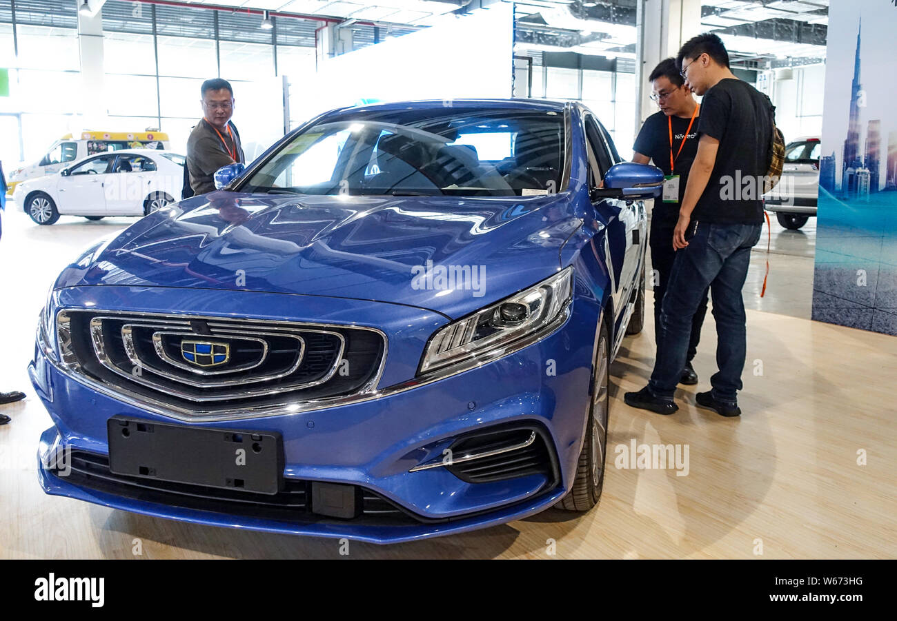 --FILE--People visit the stand of Geely during an automobile exhibition ...