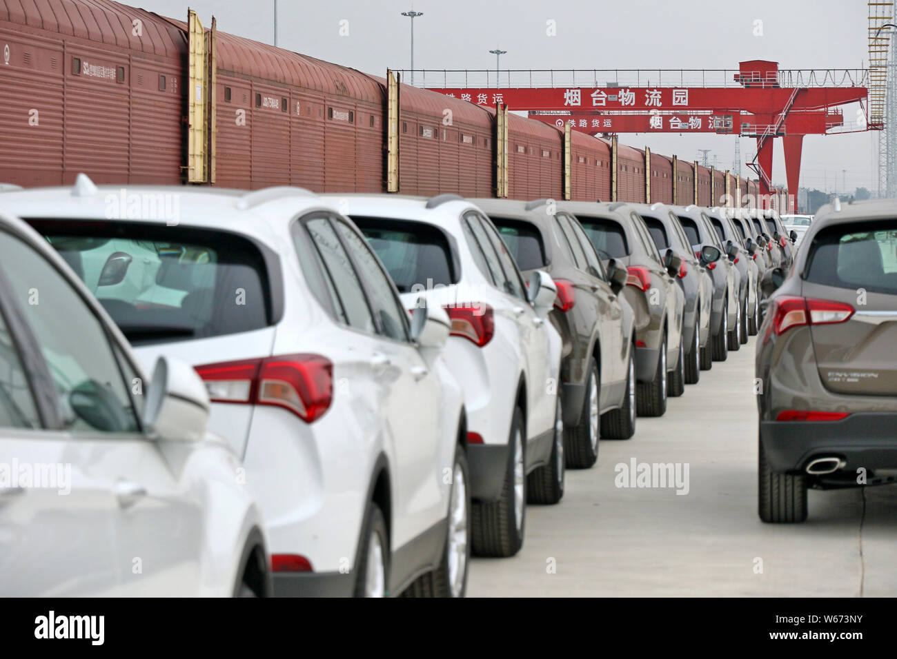 Commercial vehicles queue up to enter the first freight train carrying ...