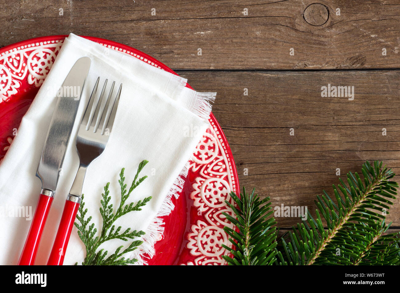 Festive table setting with red plate on wooden background Stock Photo ...