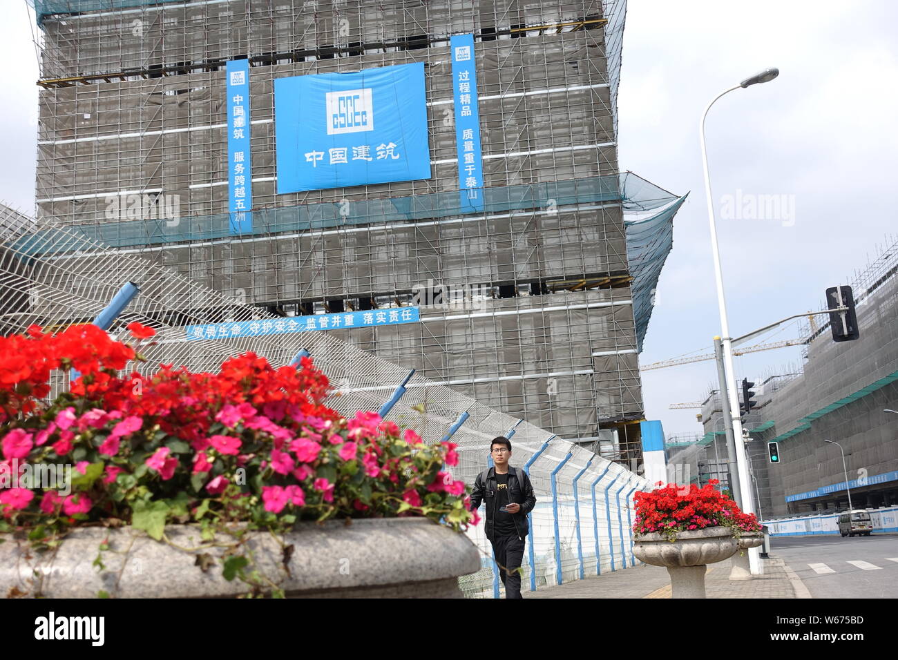 --FILE--A pedestrian walks past a construction site of CSCEC (China ...