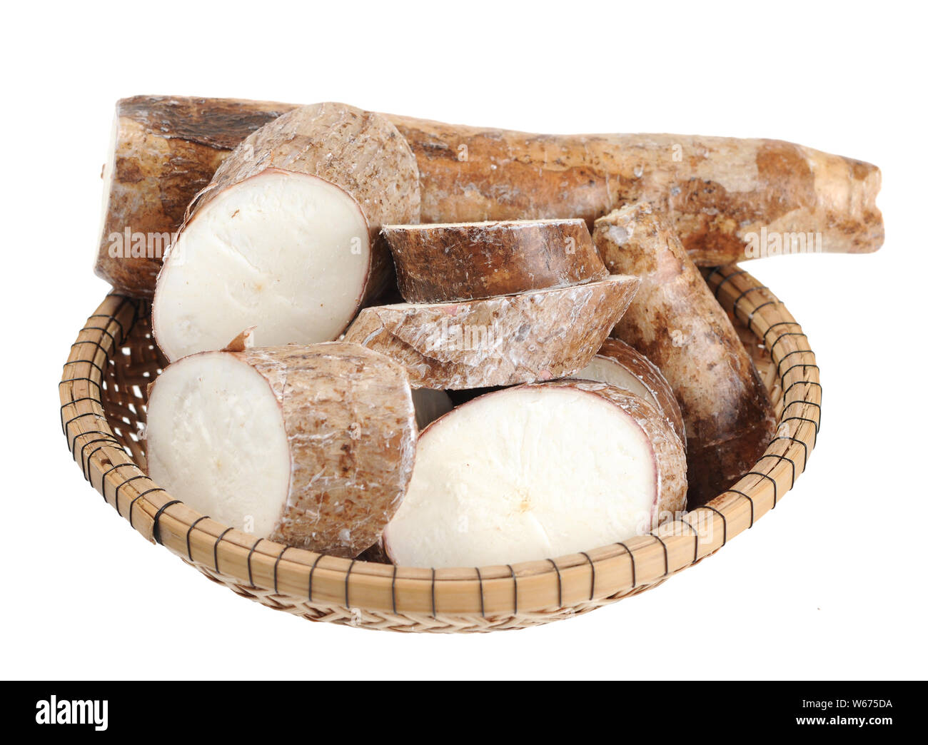 sliced manioc (cassava) in bamboo basket isolated on white background ...