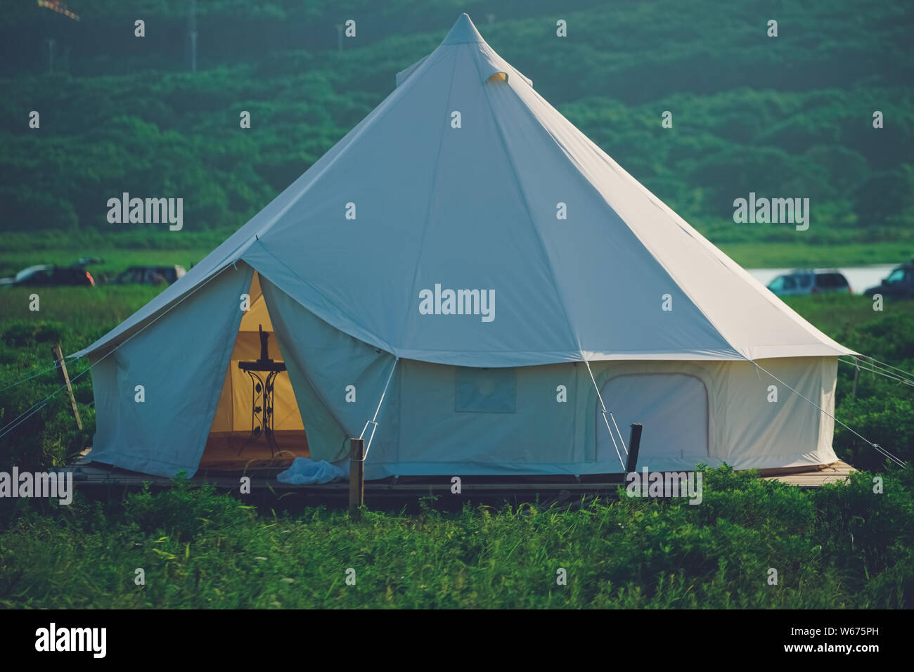 White tent on the background of the natural landscape. Travel and ...