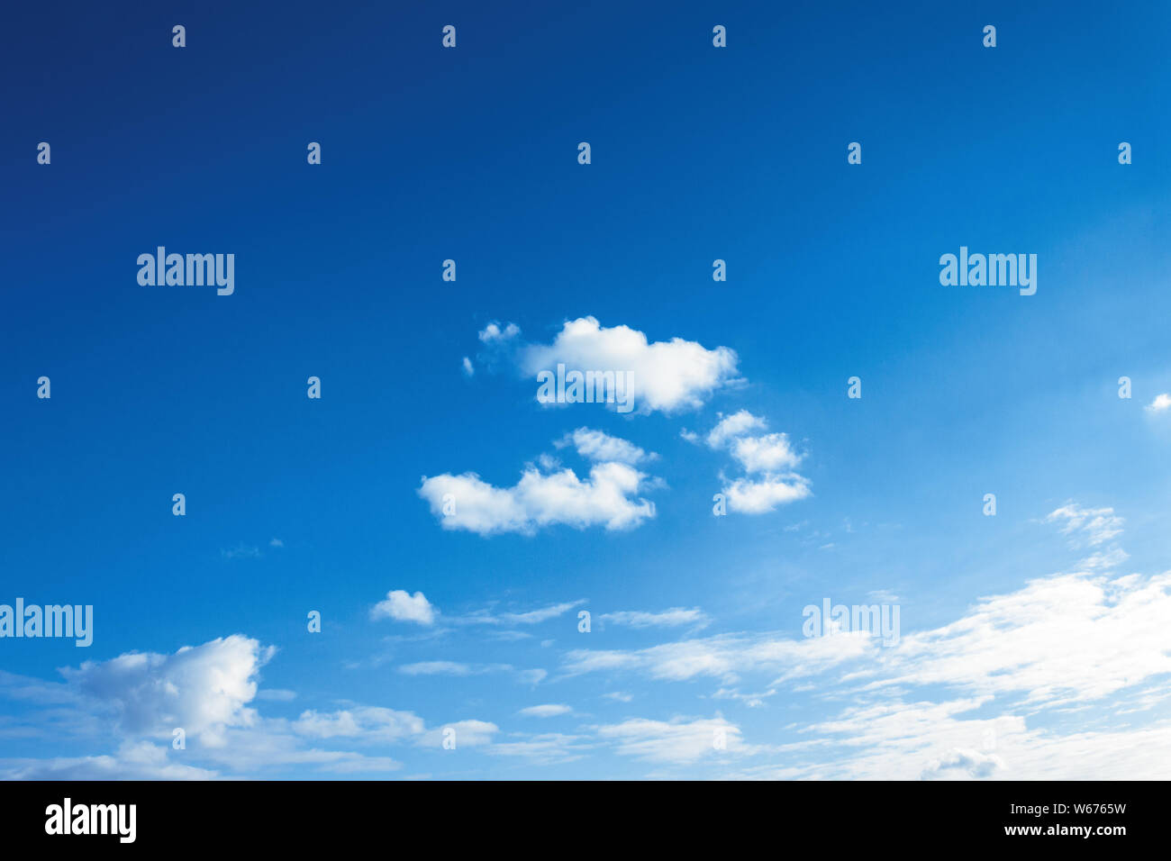 fleecy clouds on an azure sky. beautiful nature background. dynamic ...