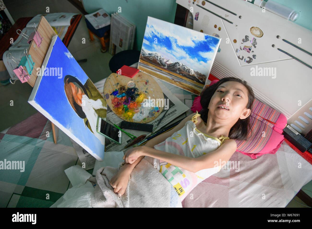 40-year-old Chinese woman Zhang Junli, who has been paralyzed since she was eight, poses with ...