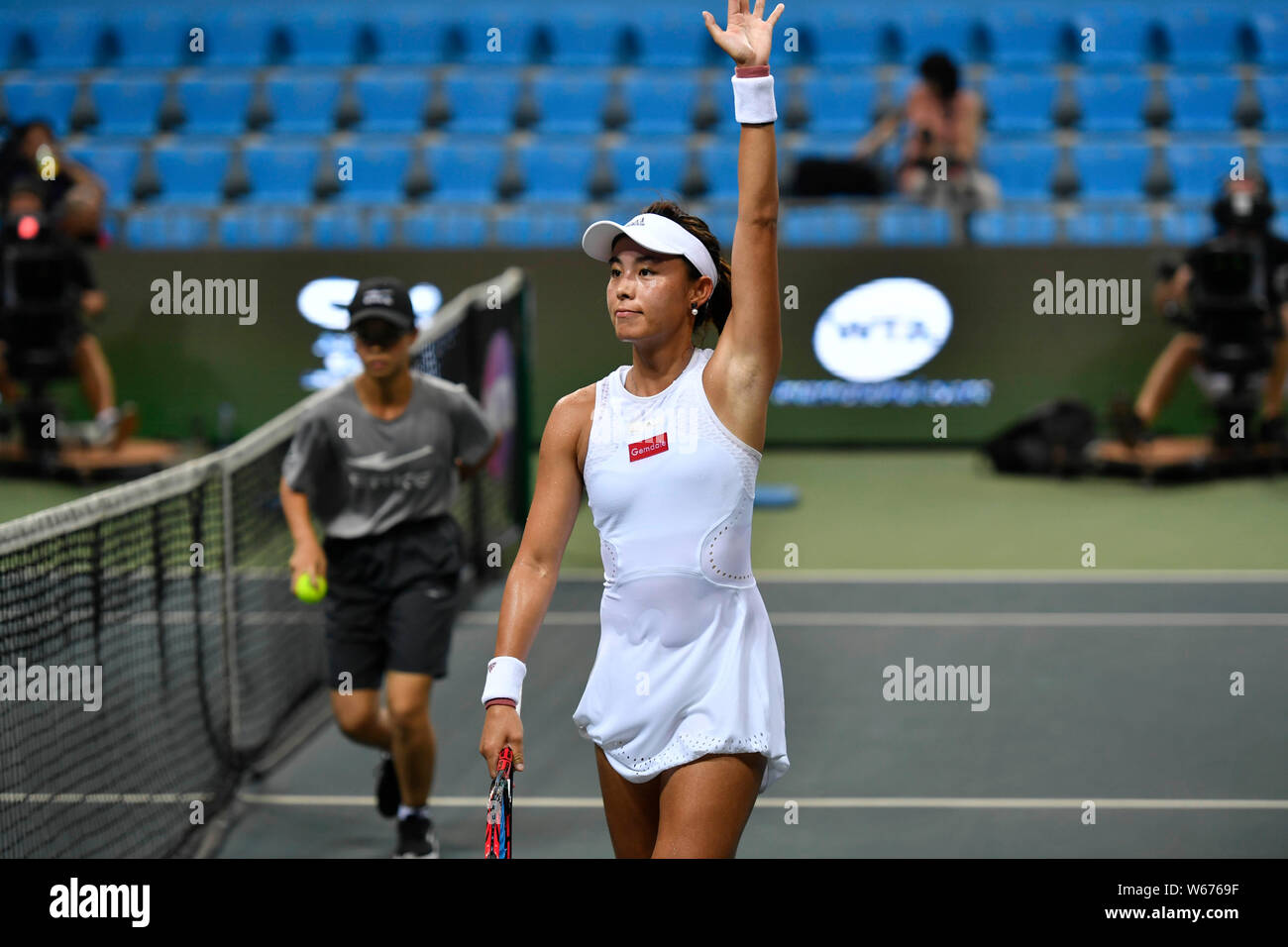 Wang Qiang of China reacts after defeating Ankita Raina of India in ...