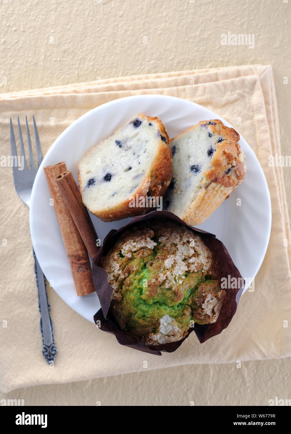 cutting muffin on the table on white background Stock Photo - Alamy