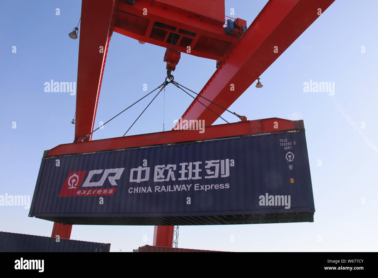 --FILE--A crane vehicle lifts a container of China Railway Express to ...