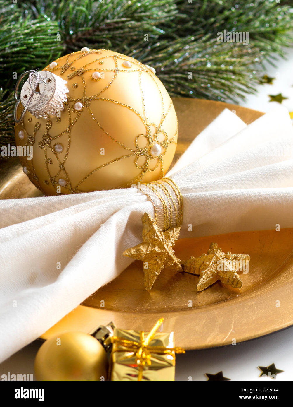 Festive table setting with golden bauble and plate Stock Photo - Alamy