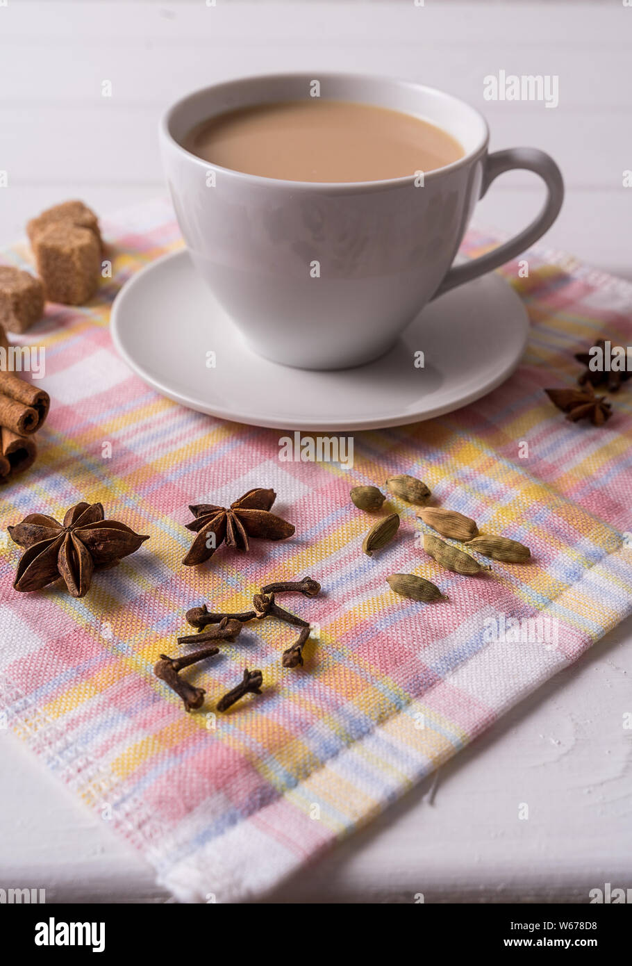 Indian traditional Masala chai tea in a cup, brown sugar, cinnamon ...