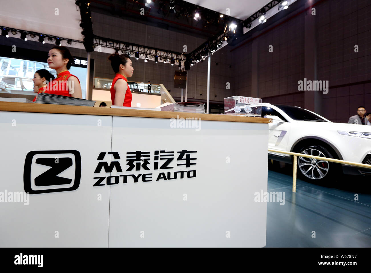 --FILE--Models are pictured at the stand of Zotye Auto during the 16th ...