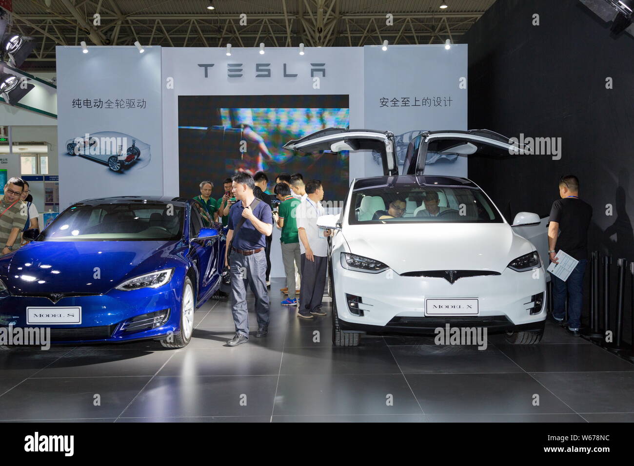 --FILE--People visit the stand of Tesla during an automobile exhibition ...