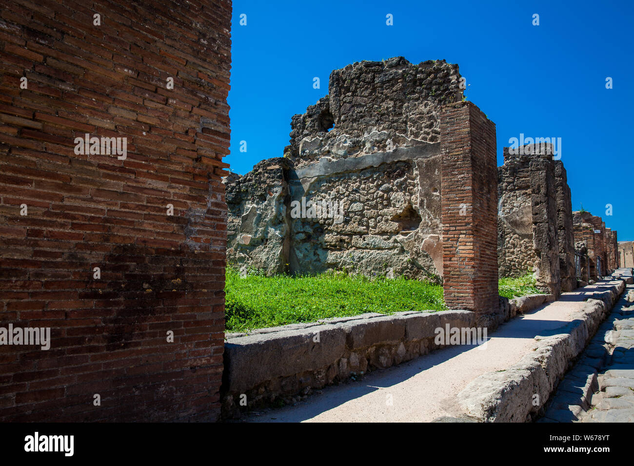 The streets of Pompeii made of large blocks of black volcanic rocks ...