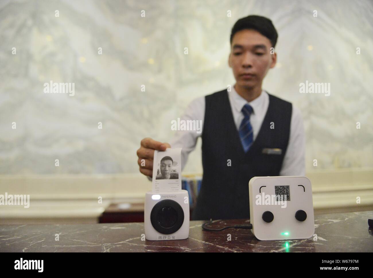 A Chinese mobile phone user uses his electronic identification card in ...