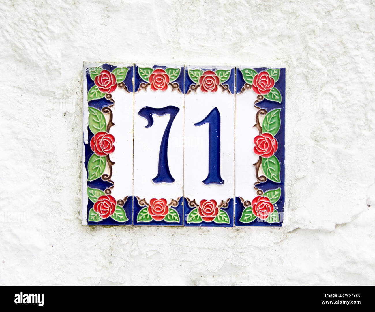 Ceramic Number 71 on the white wall Stock Photo - Alamy