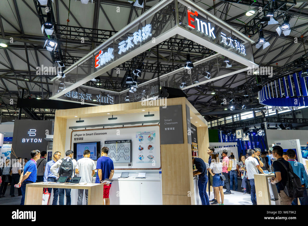 --FILE--People visit the stand of E Ink Holdings Inc, the world's ...