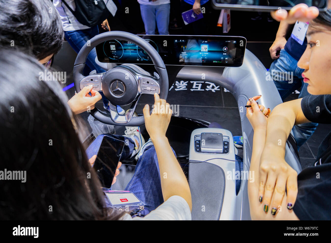 --FILE--Visitors try out MBUX smart multimedia system and in-car voice ...