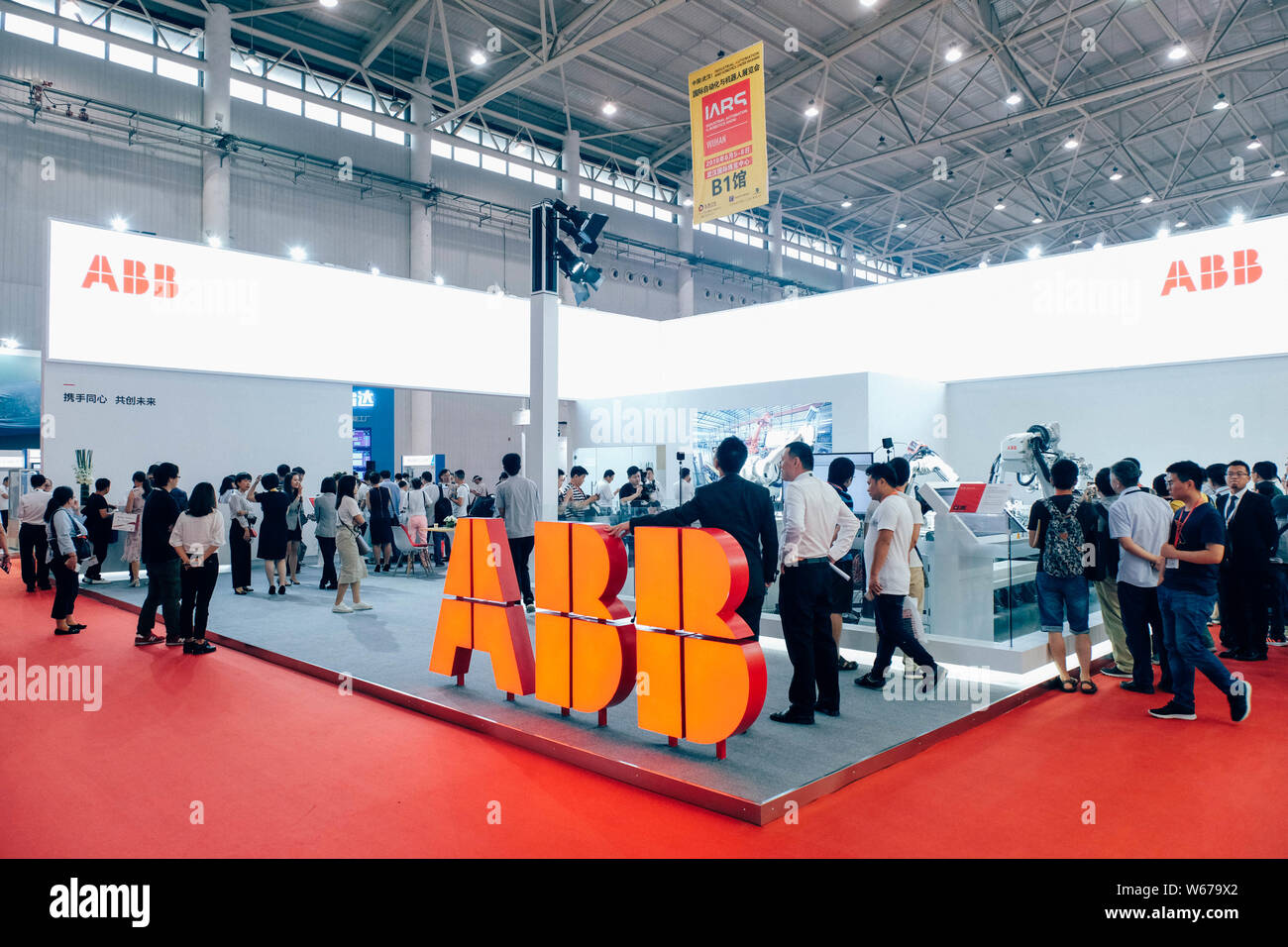 --FILE--People visit the stand of ABB Group during the Industrial ...