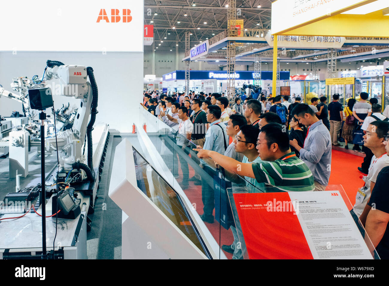 --FILE--People visit the stand of ABB Group during the Industrial ...