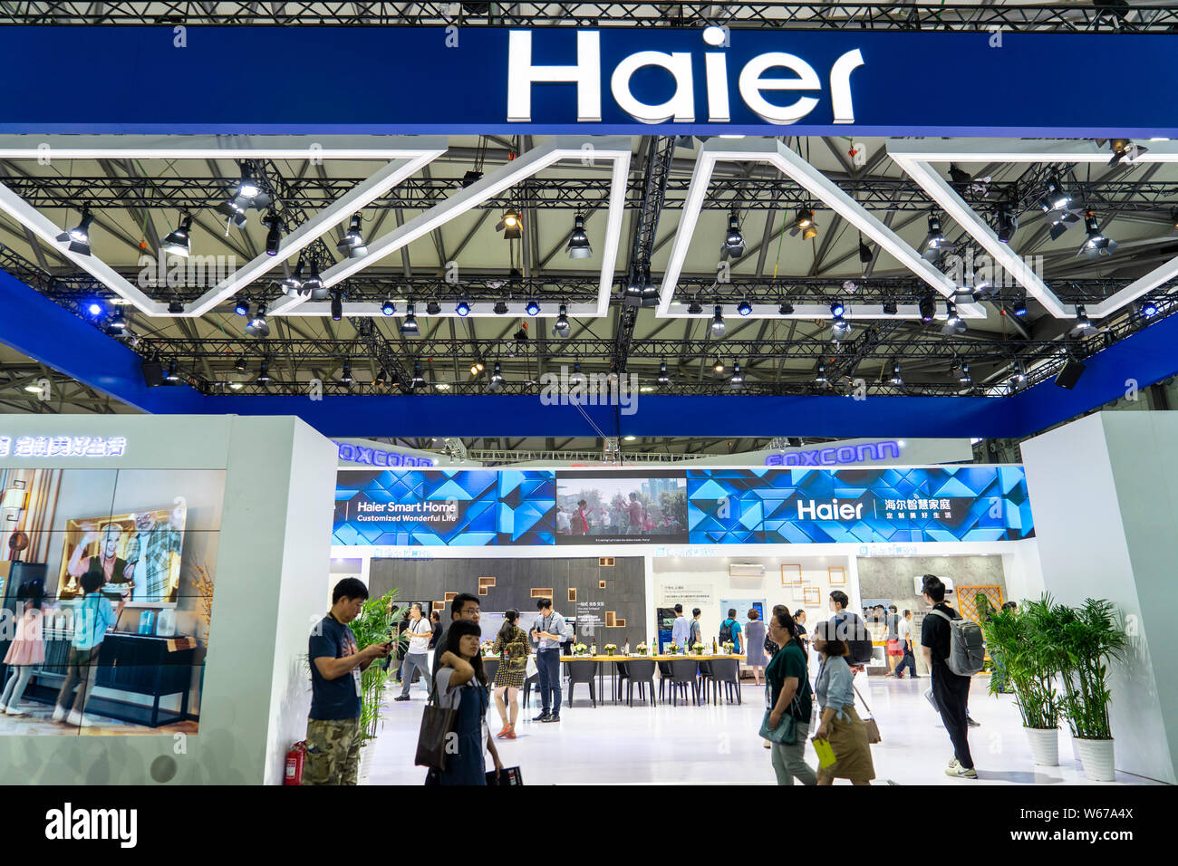 --FILE--People visit the stand of Haier during an exhibition in ...