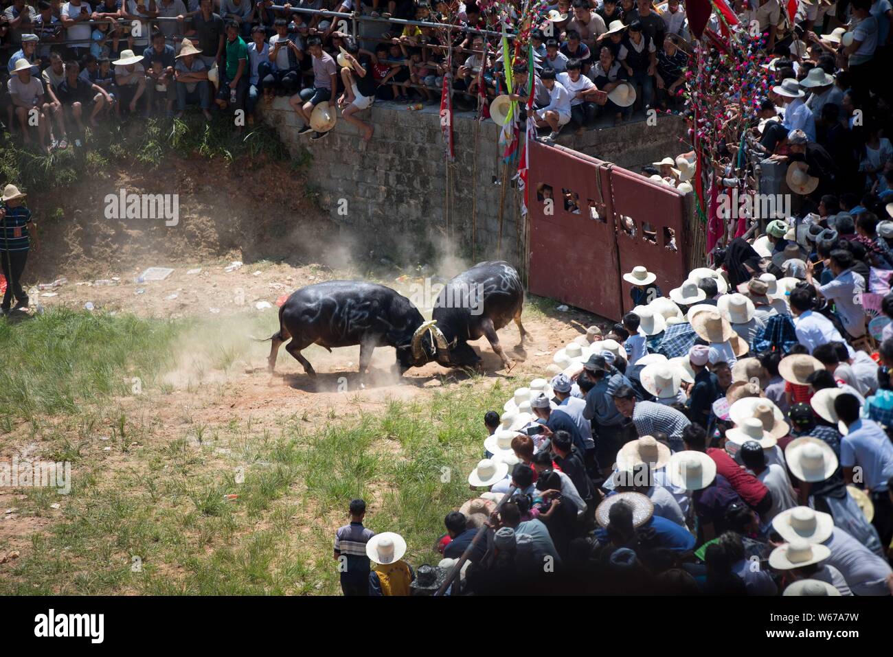 Visitors and local people of Miao and Dong ethnical minorities watch a ...