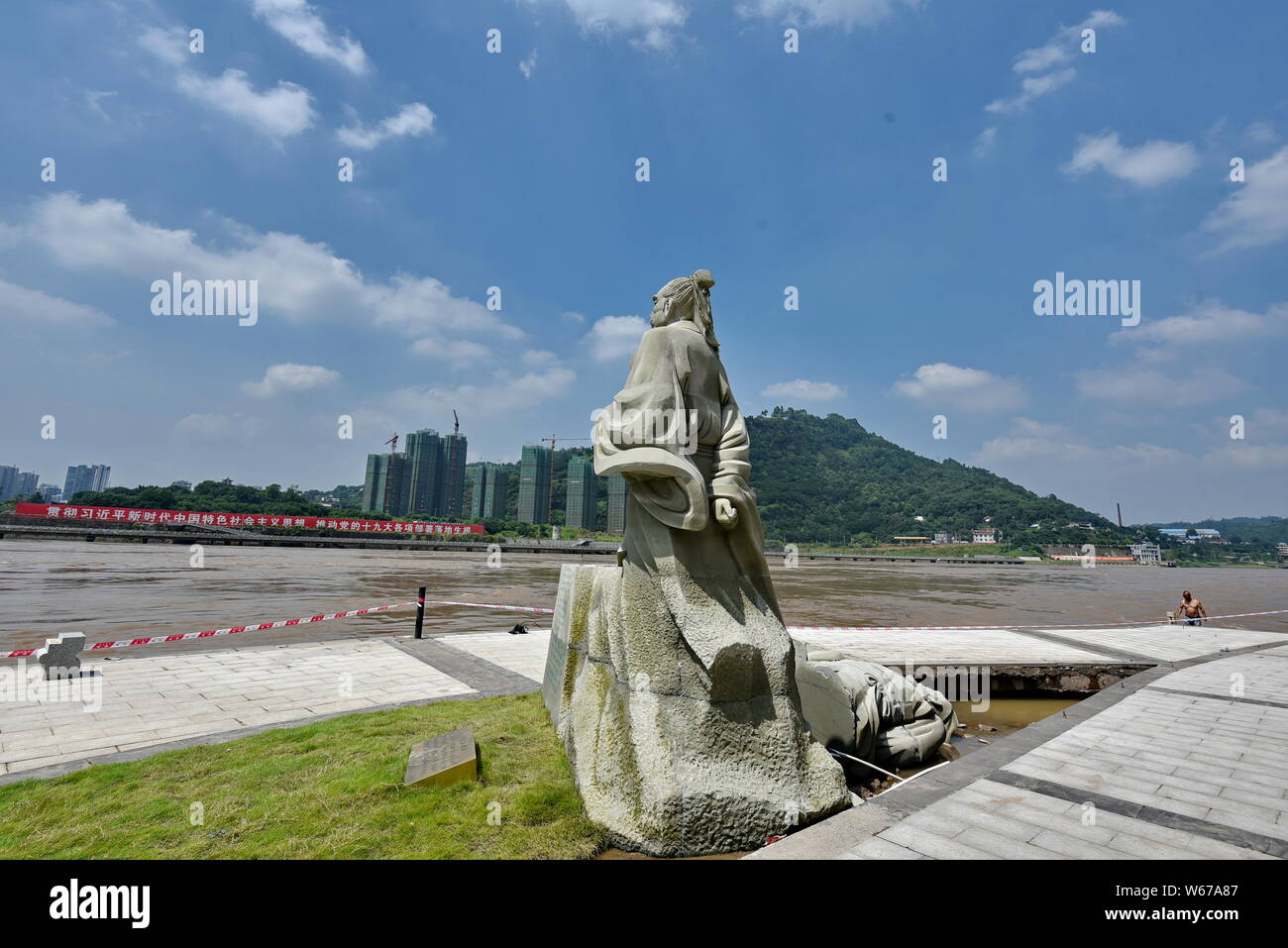 View of the standing statue of Huang Tingjian and the damaged statue of ...