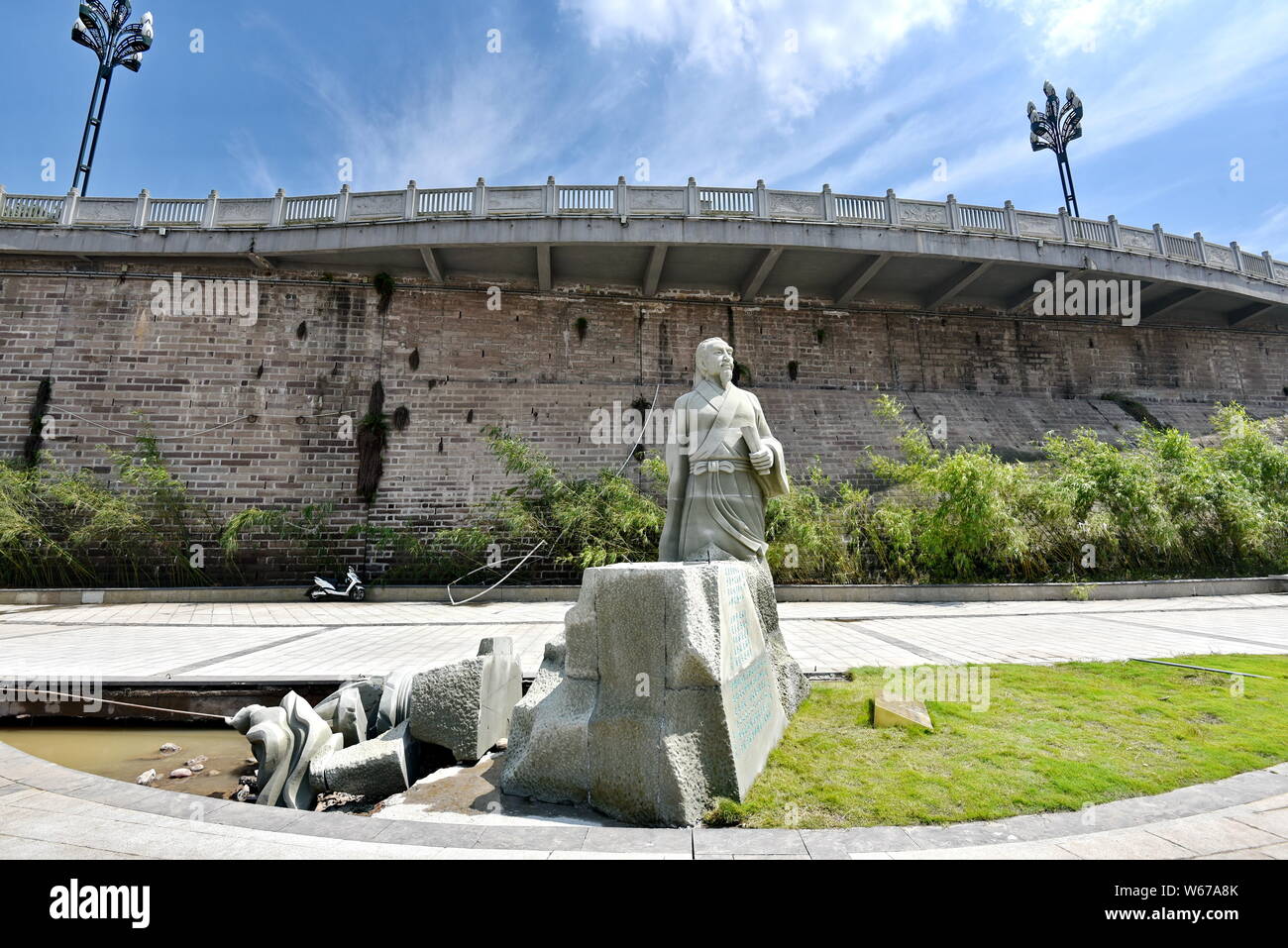 View of the standing statue of Huang Tingjian and the damaged statue of ...