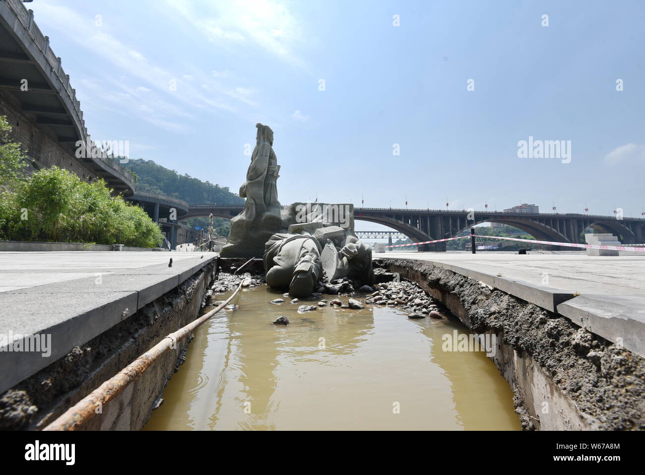 View of the standing statue of Huang Tingjian and the damaged statue of ...