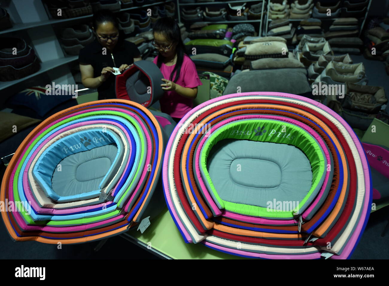 Chinese female workers process fabric doghouses to be exported at a ...