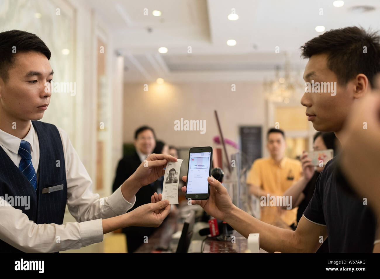 A Chinese mobile phone user uses his electronic identification card in ...